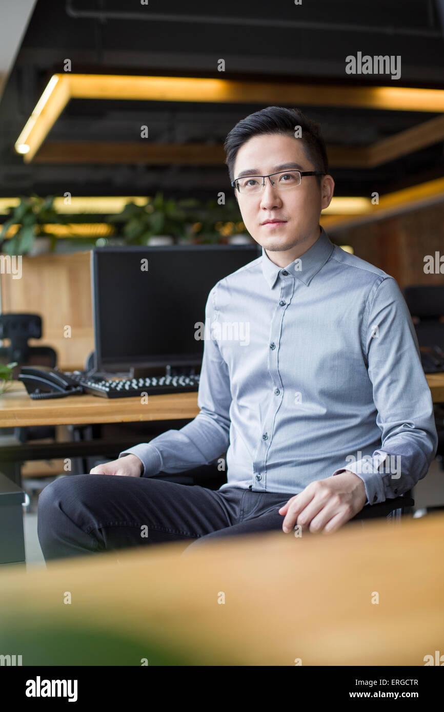IT worker sitting in office Stock Photo - Alamy