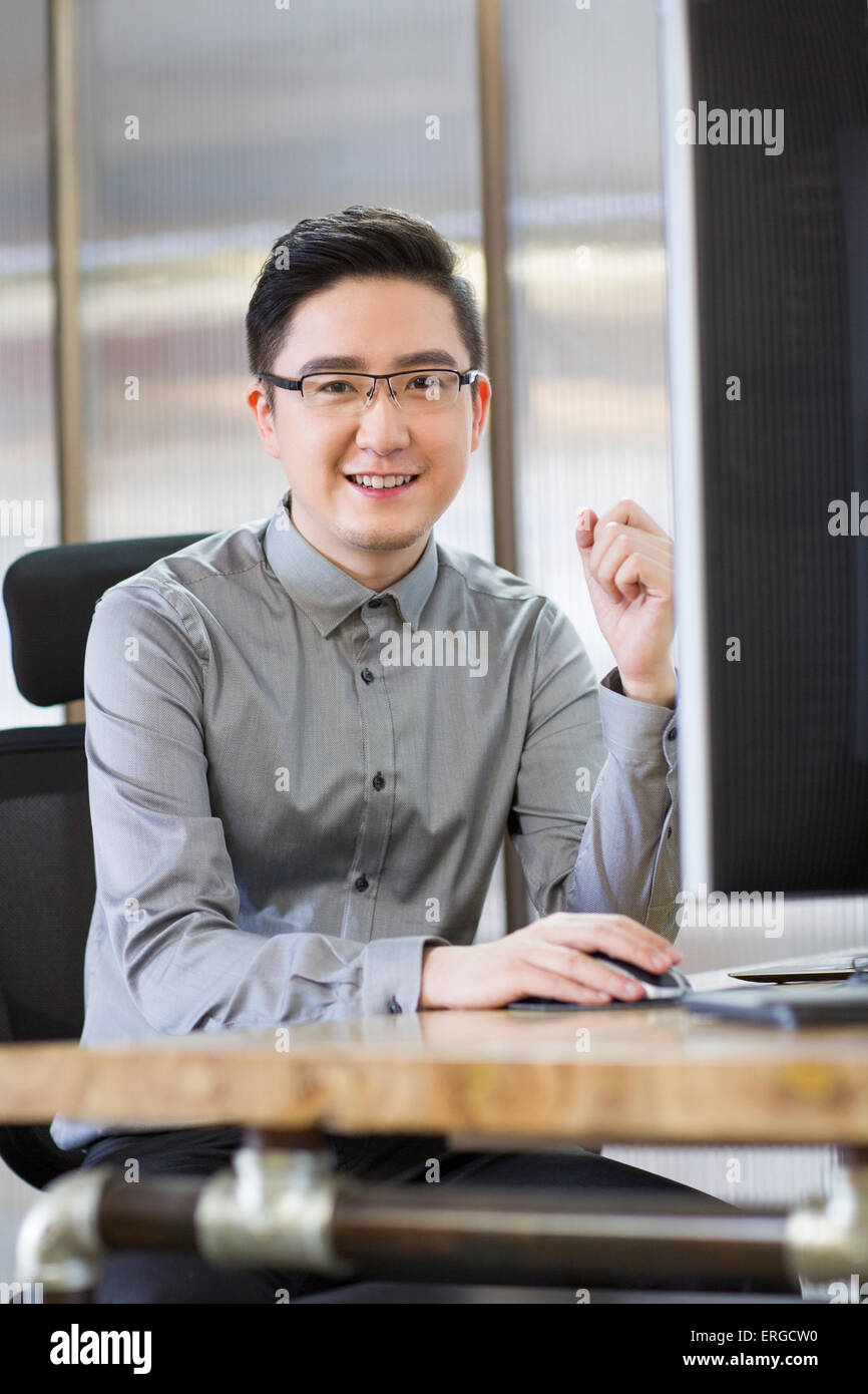 IT worker sitting in office Stock Photo - Alamy