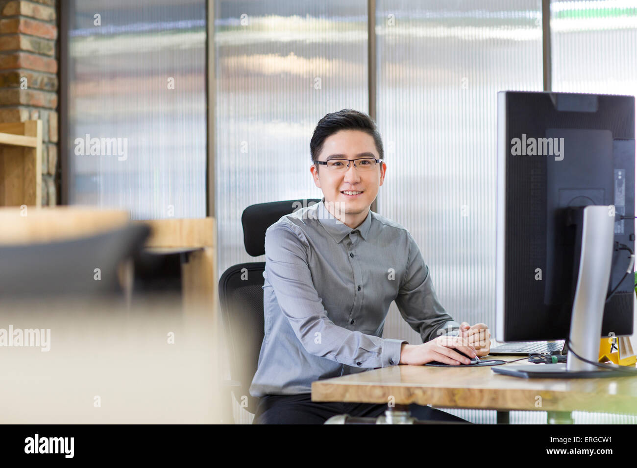 IT worker sitting in office Stock Photo - Alamy