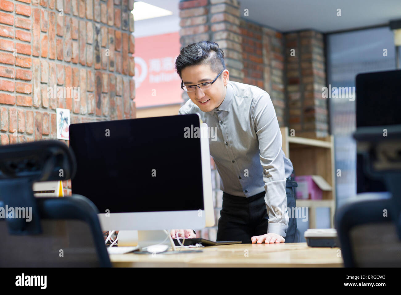 IT worker working in office Stock Photo - Alamy