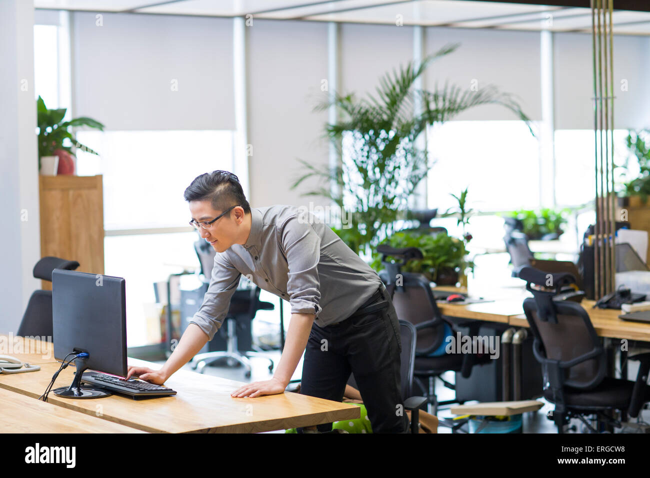 IT worker working in office Stock Photo - Alamy