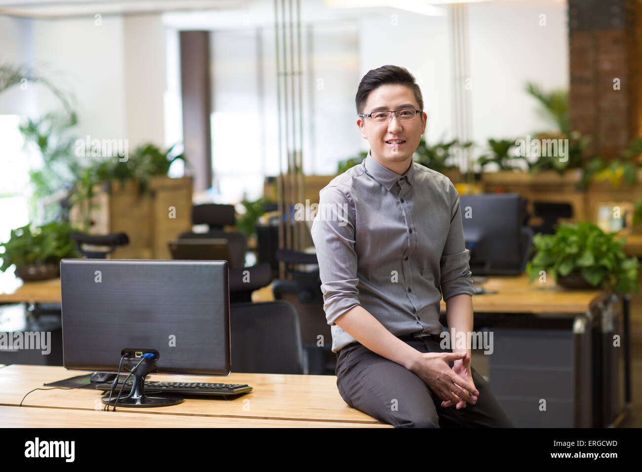 IT worker sitting in office Stock Photo - Alamy