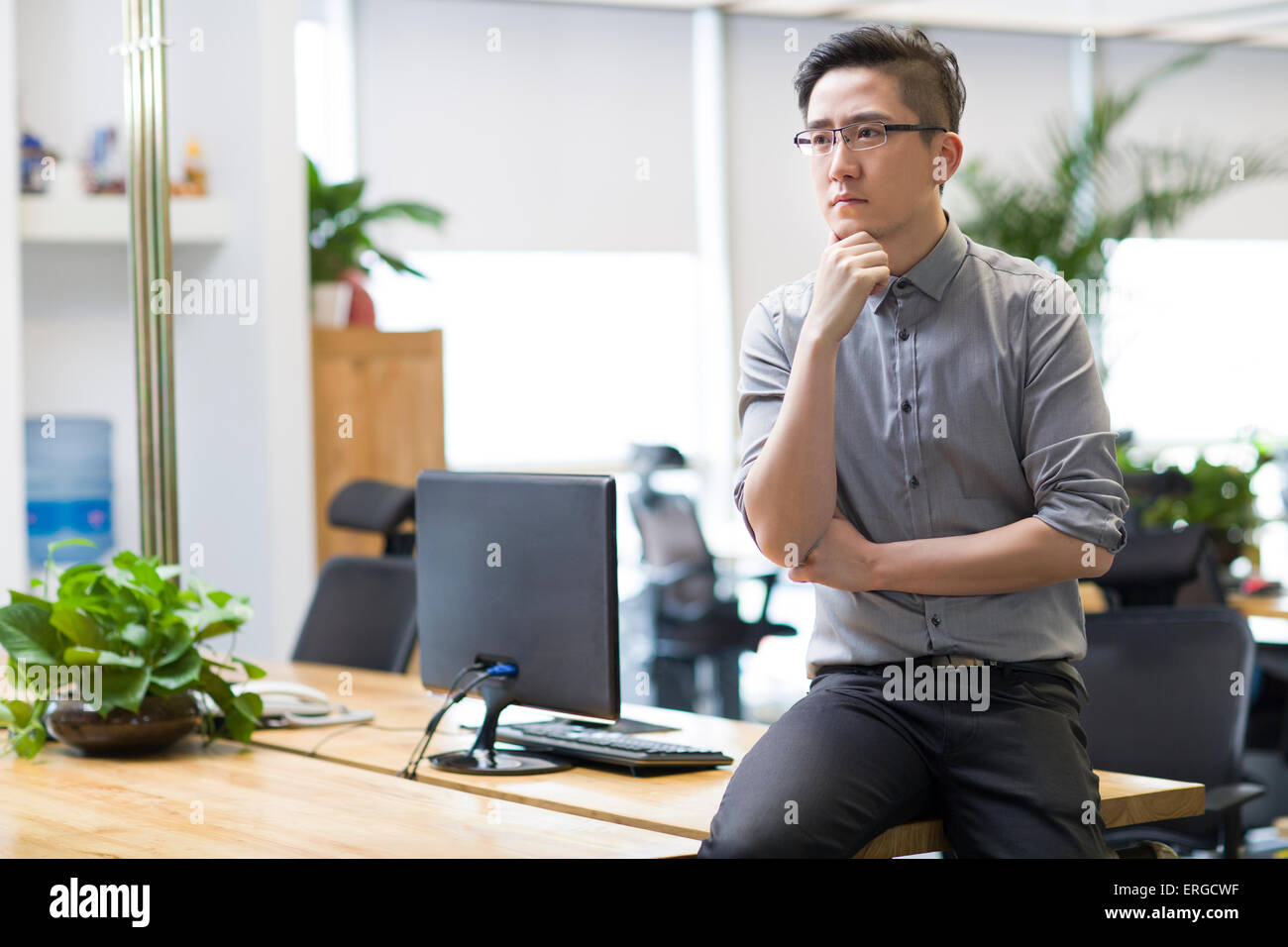 IT worker thinking in office Stock Photo - Alamy
