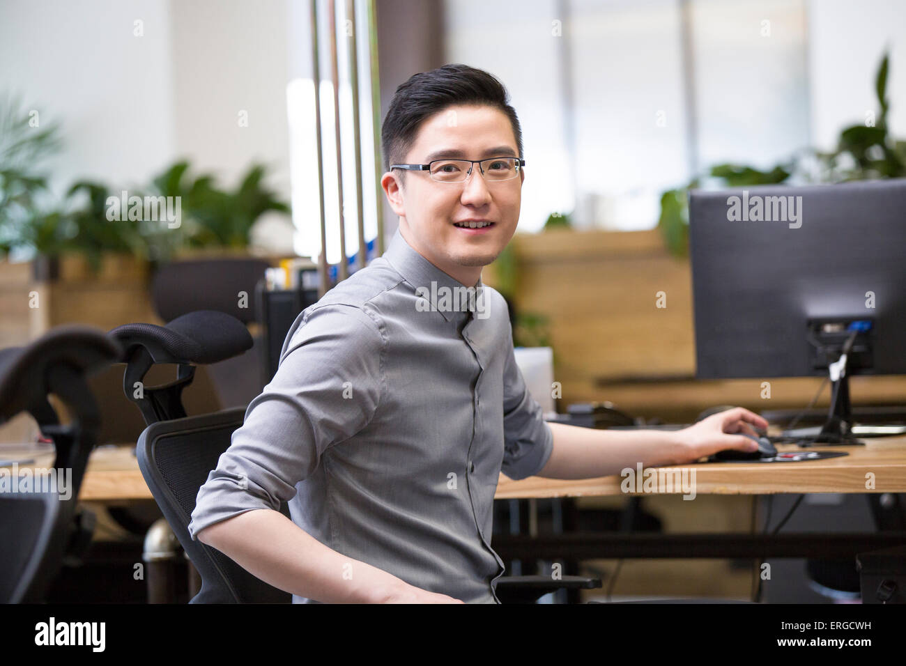 IT worker sitting in office Stock Photo - Alamy