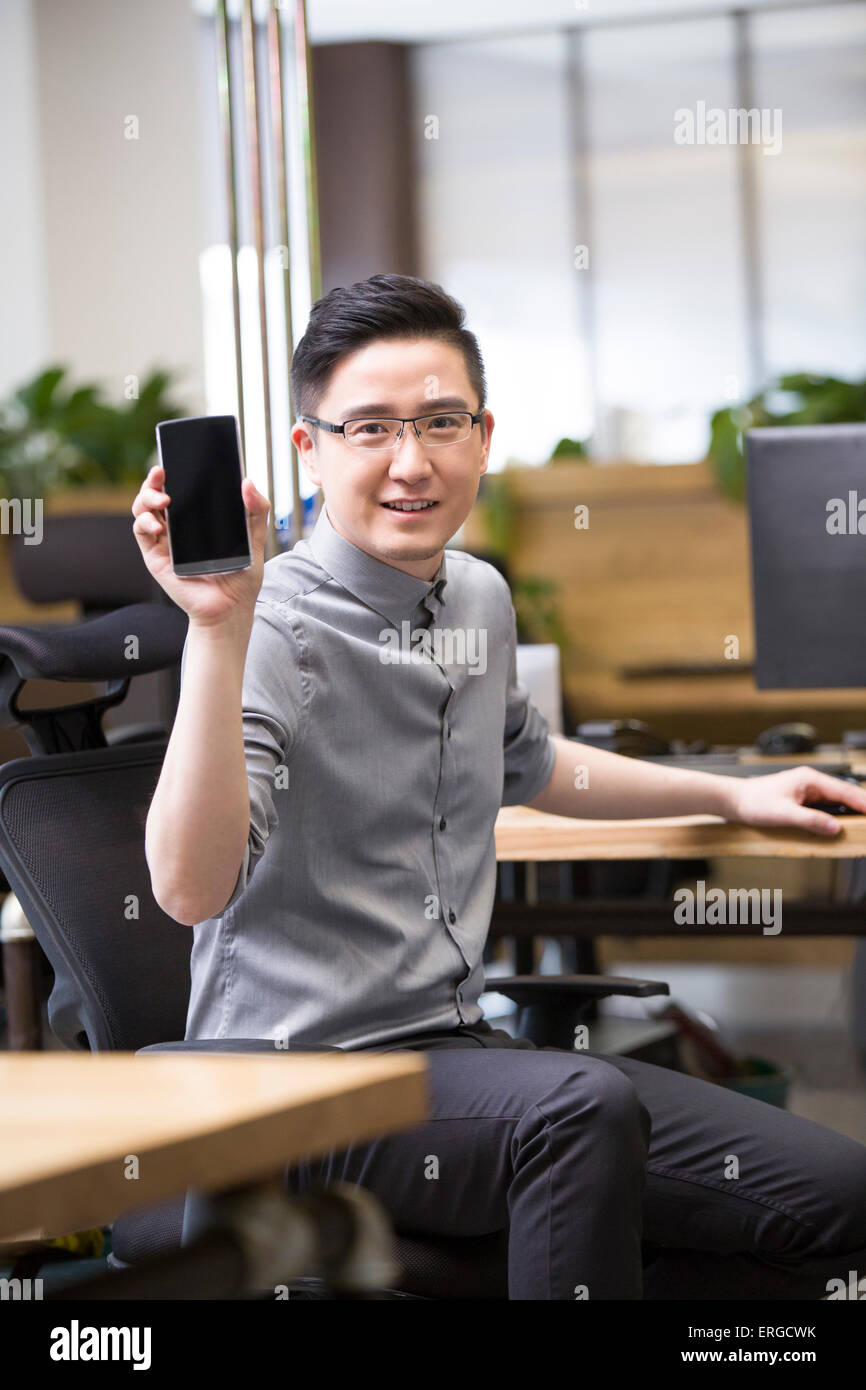 IT worker showing a smart phone Stock Photo - Alamy