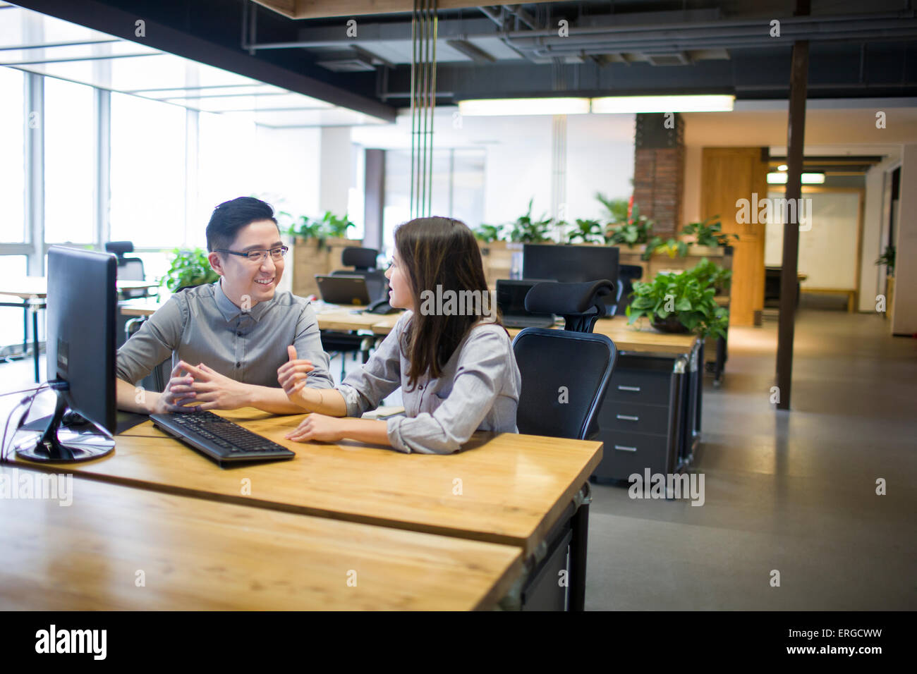IT workers talking in office Stock Photo - Alamy