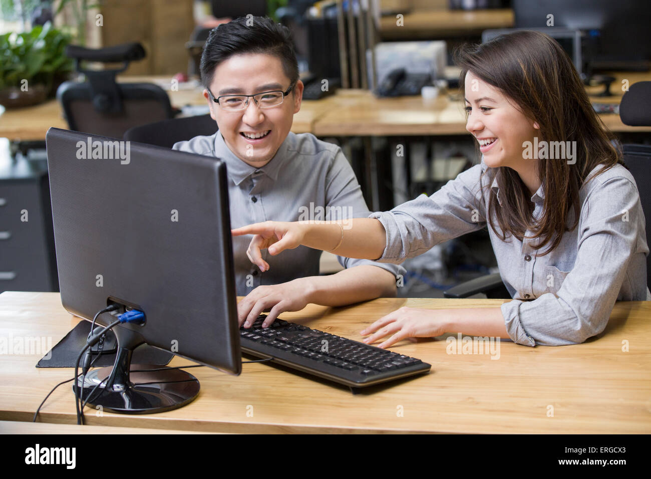 IT workers talking in office Stock Photo - Alamy