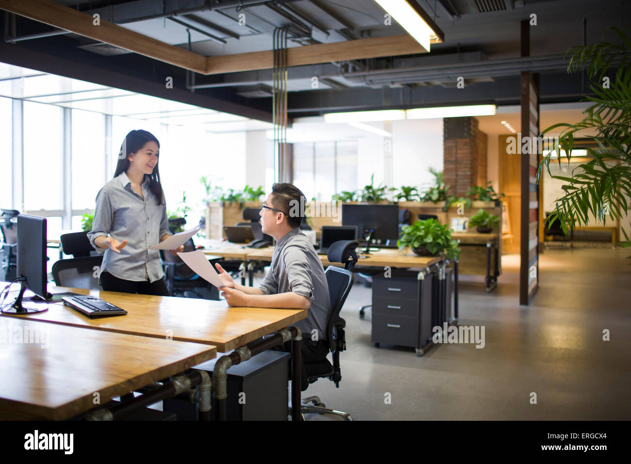 IT workers talking in office Stock Photo - Alamy