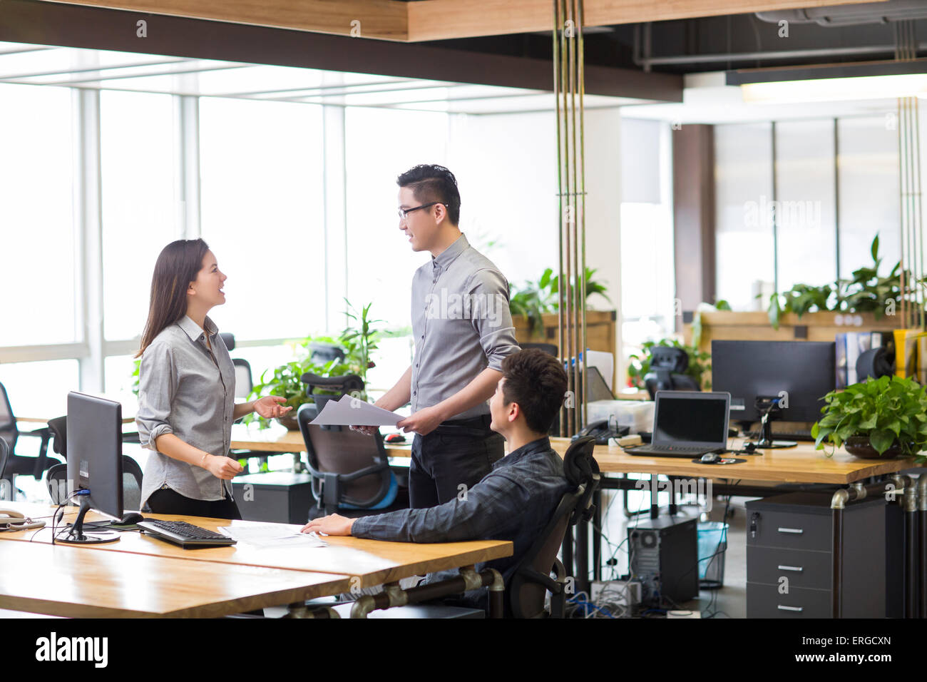 IT workers talking in office Stock Photo - Alamy