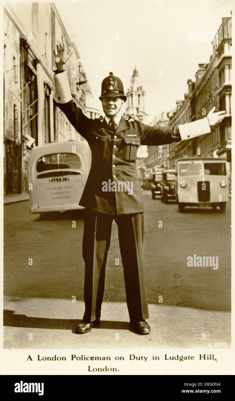 A London policeman, 1950s. Shows a policeman directing traffic at ...
