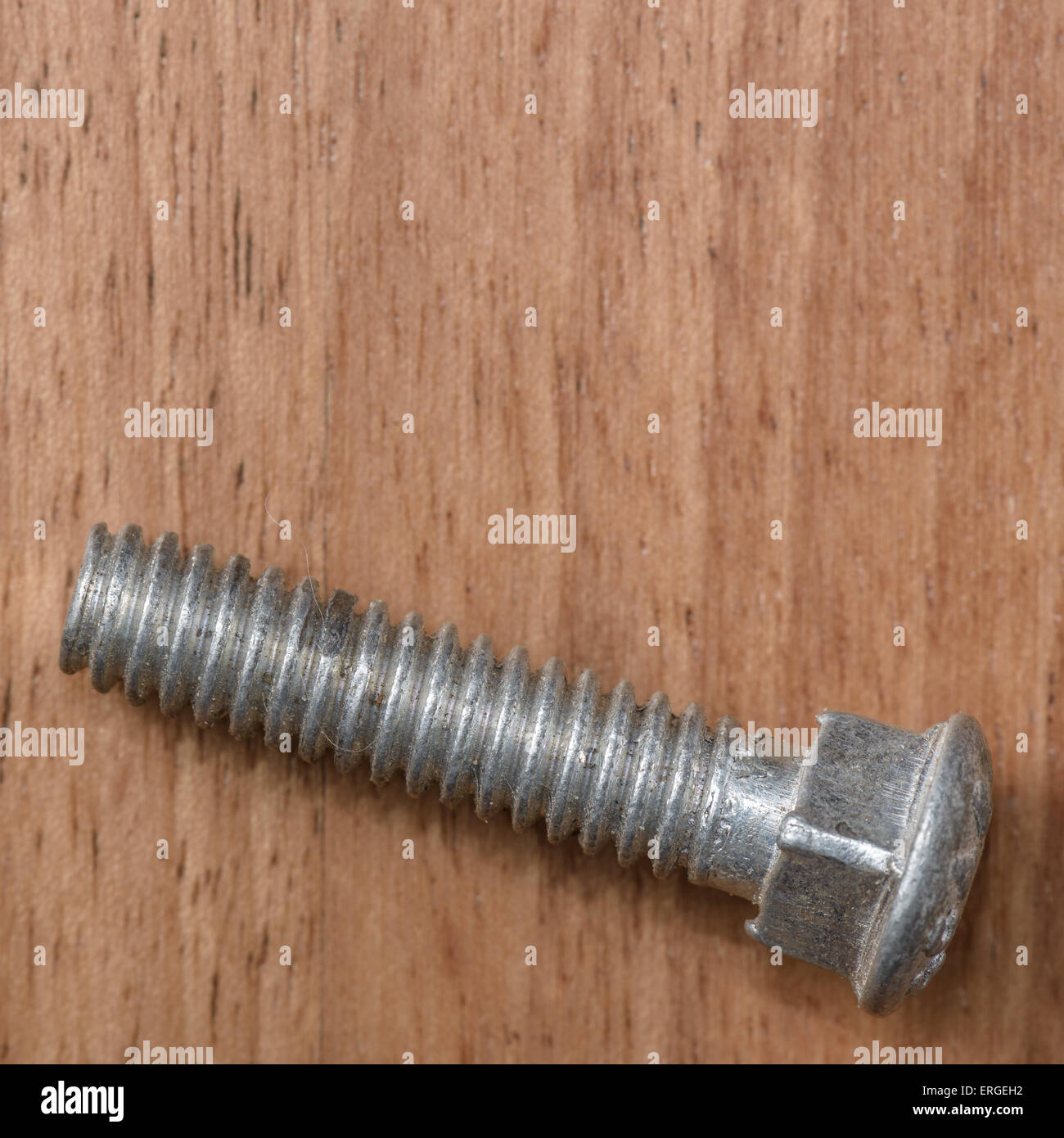 One bolt on wood blur background Stock Photo - Alamy