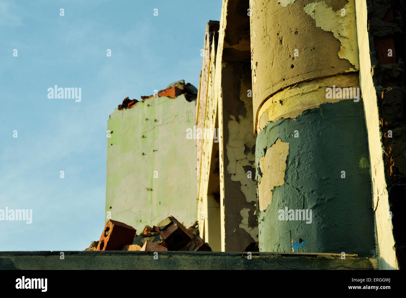 Rubble and concrete pillar with peeling paint of abandoned building ...