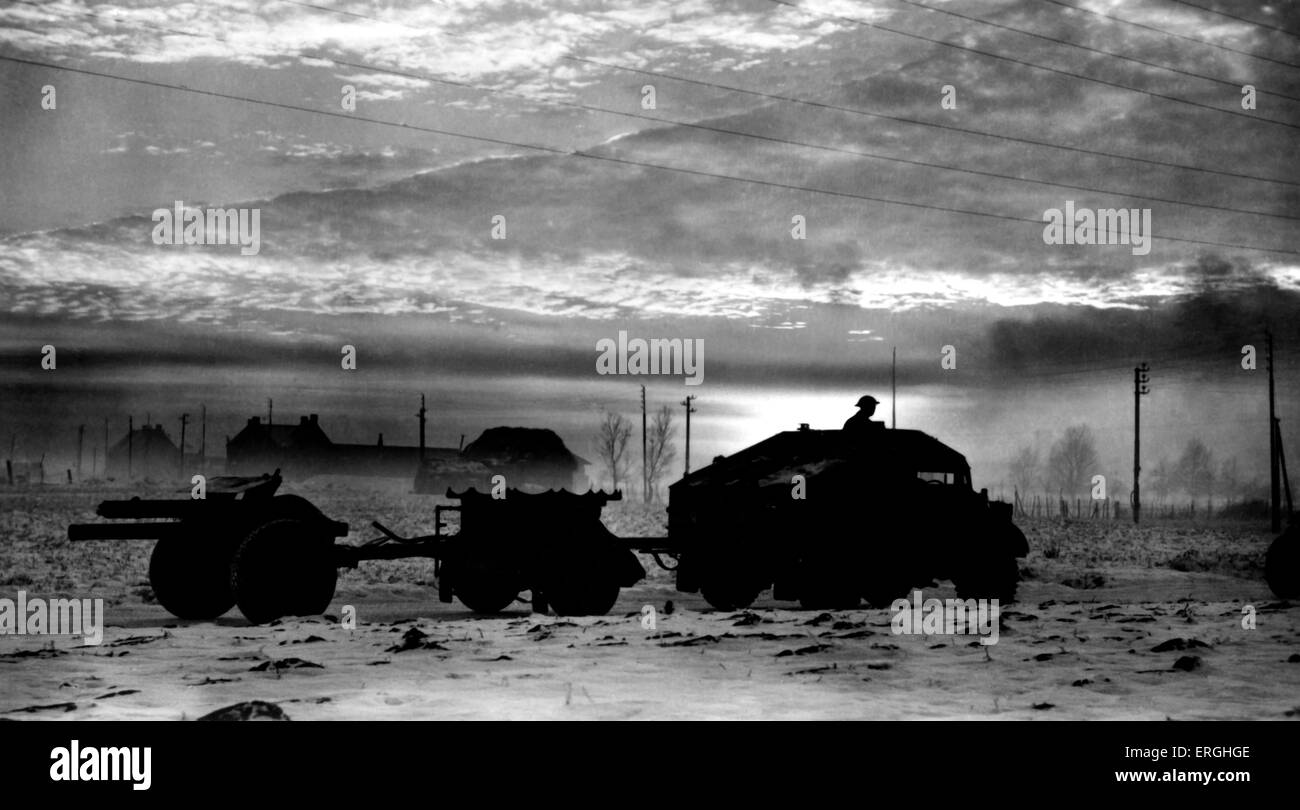 World War 2: Sunset on the Western Front. Caption: A British gun is ...