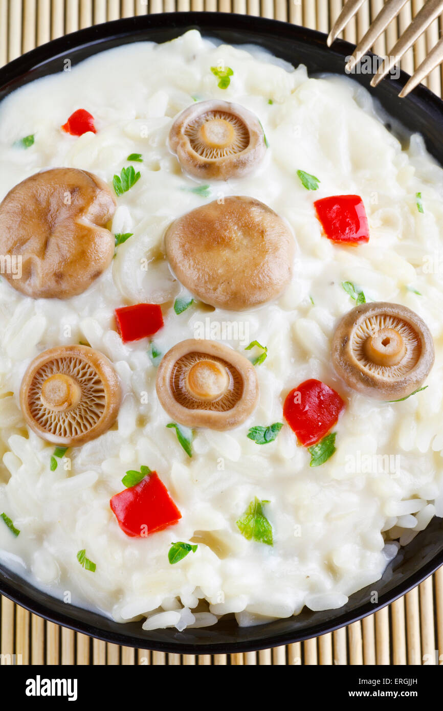 Close up of a Saffron Milk Cap mushroom rice on a bowl on a bamboo mat ...