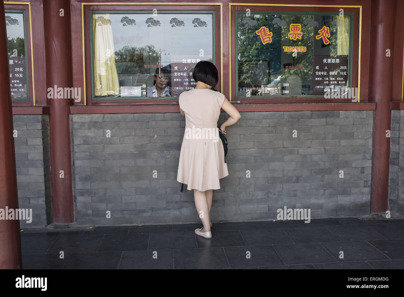 a woman buys the tickets at Beihai park, Beijing, China. 3rd June, 2015 ...