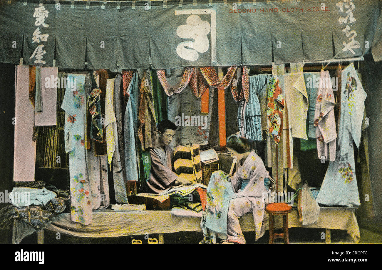 Japan. Japanese woman purchasing kimono in market from trader at market ...