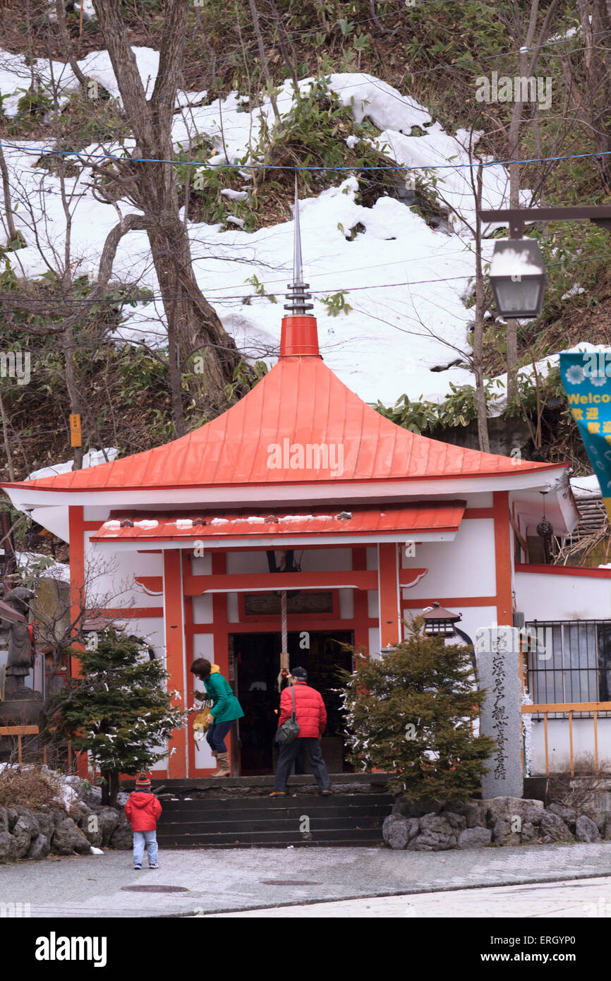 A small Shinto shrine beside the road in the town of Jozankei, a hot ...