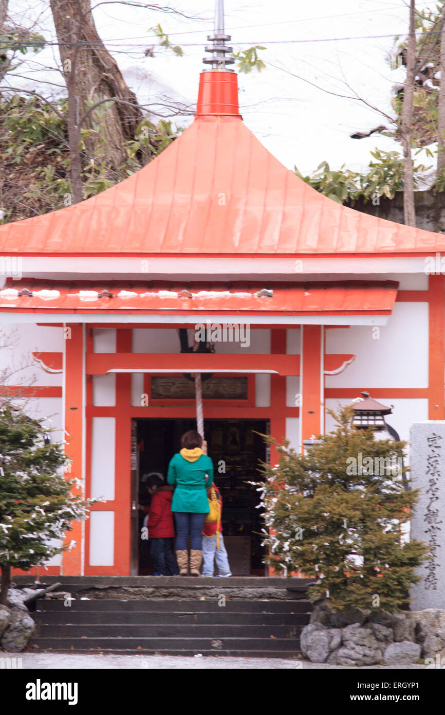A small Shinto shrine beside the road in the town of Jozankei, a hot ...