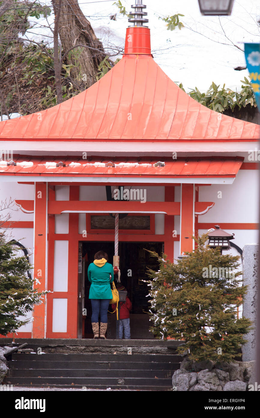 A small Shinto shrine beside the road in the town of Jozankei, a hot ...