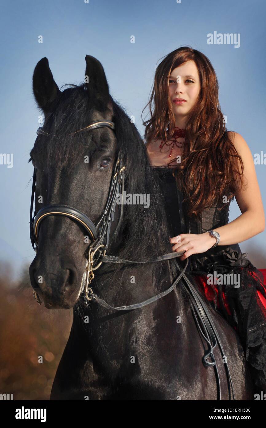 woman rides Frisian horse Stock Photo - Alamy