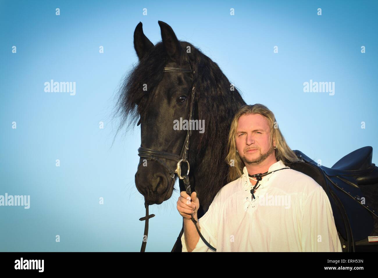 man and Frisian horse Stock Photo - Alamy