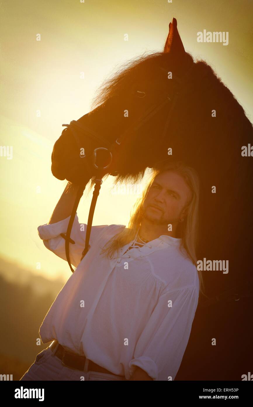 man and Frisian horse Stock Photo - Alamy