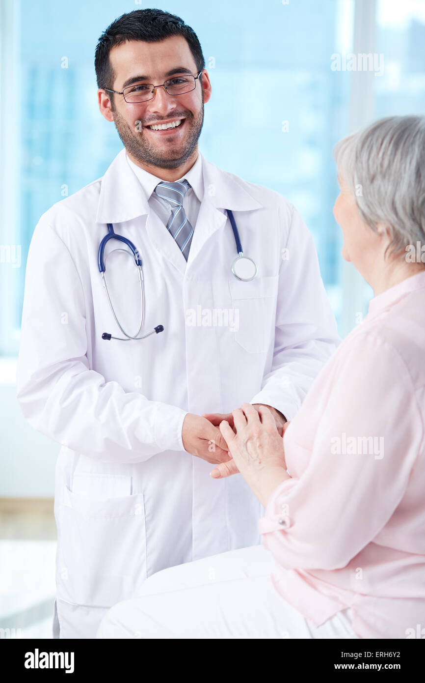 Smiling doctor taking care of his patient in hospital Stock Photo - Alamy