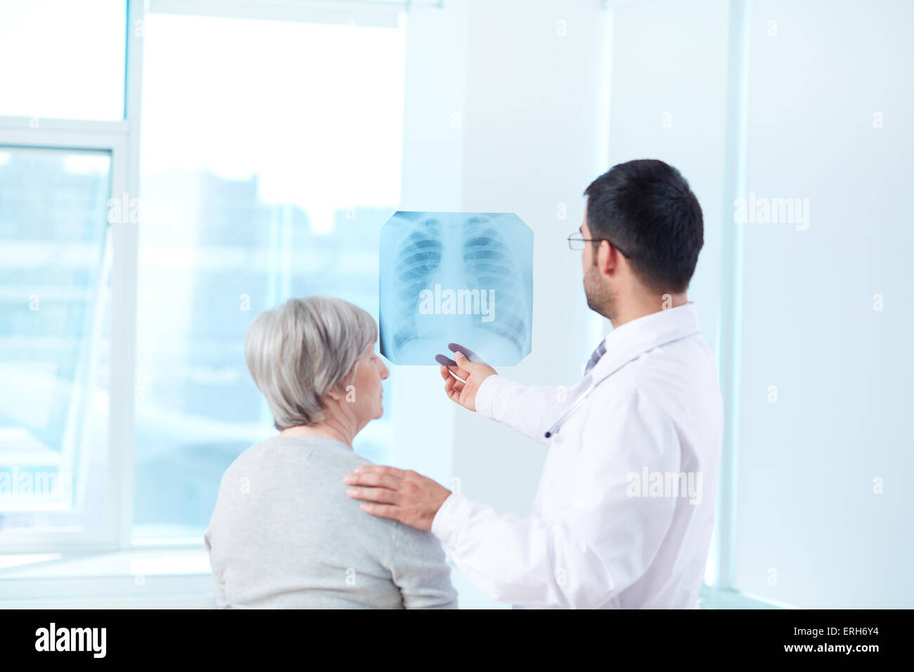 Male doctor showing x-ray to his patient in hospital Stock Photo - Alamy