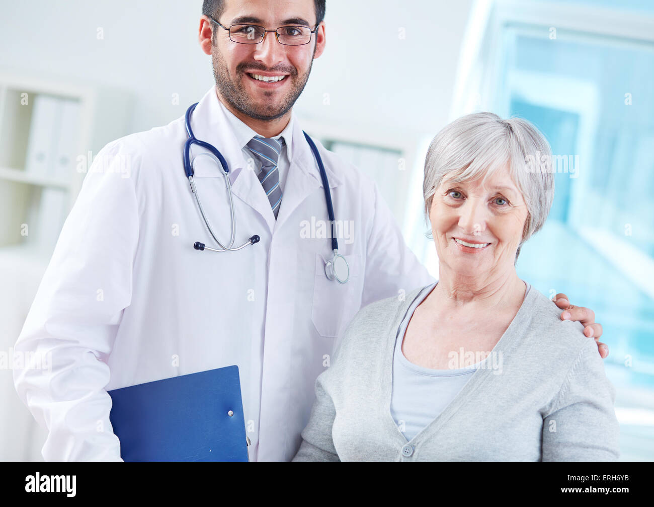 Happy young doctor and elderly female patient Stock Photo - Alamy