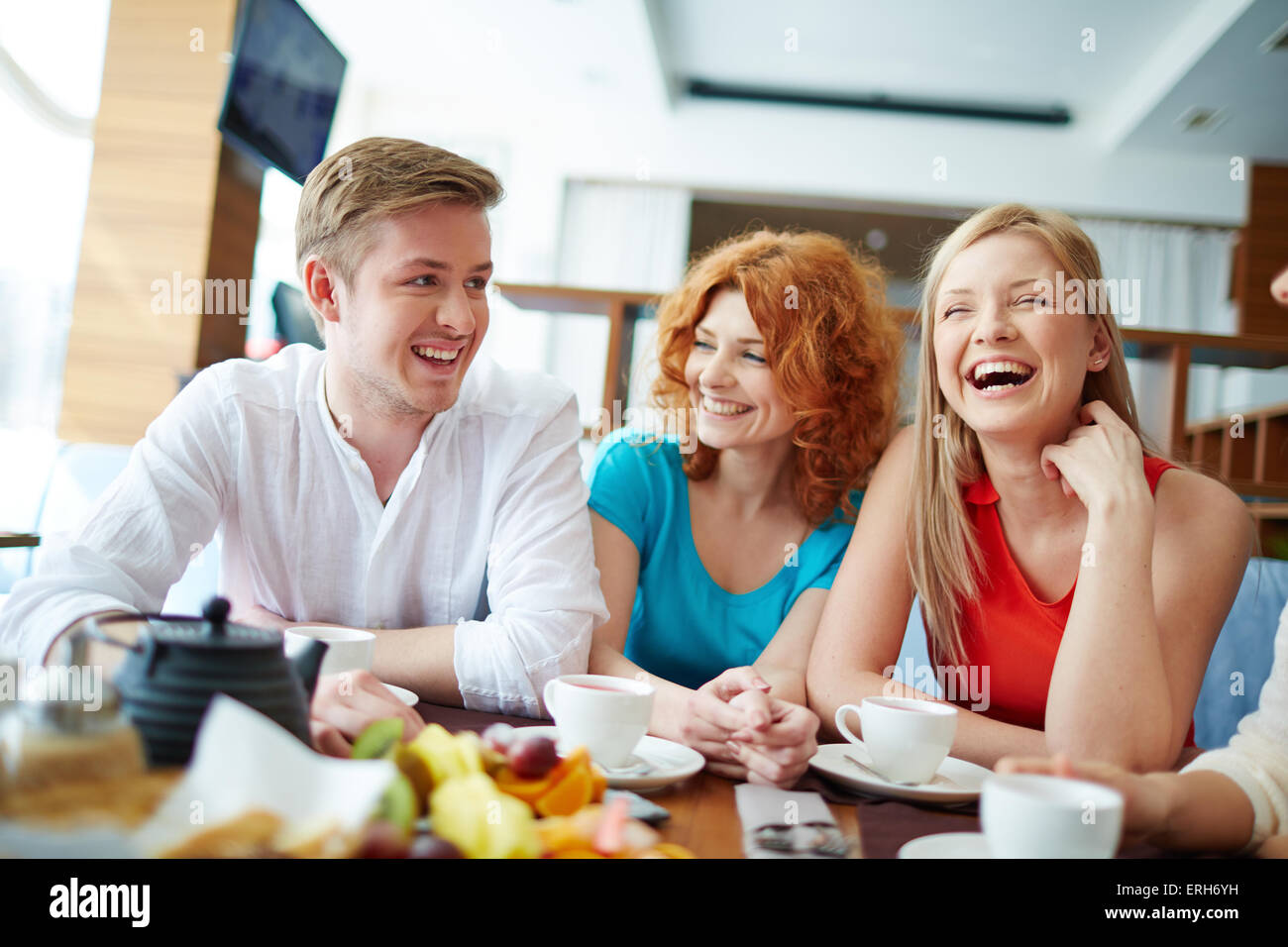 Joyful friends having coffee with dessert in cafe Stock Photo - Alamy