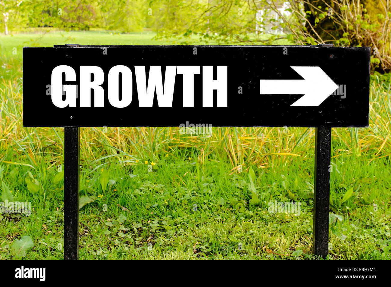 GROWTH written on directional black metal sign with arrow pointing to ...