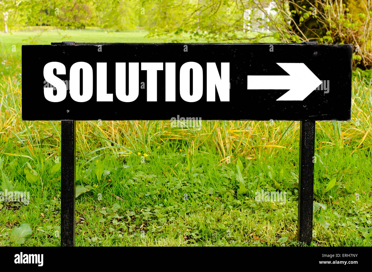 SOLUTION written on directional black metal sign with arrow pointing to ...