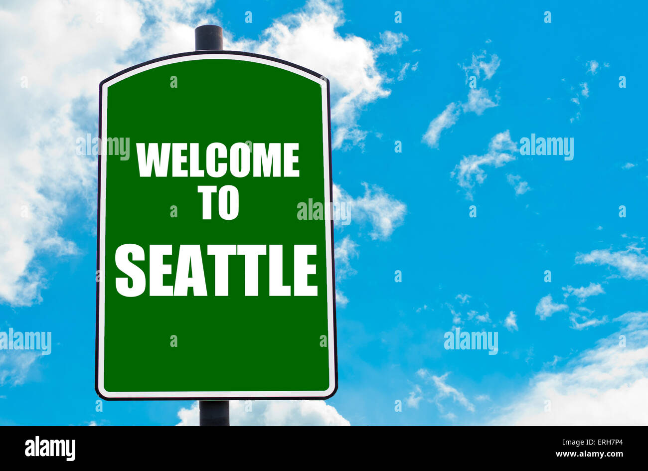 Green road sign with greeting message Welcome to SEATTLE isolated over ...