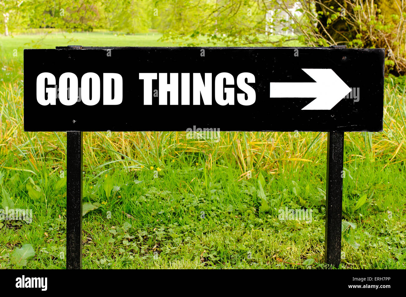 GOOD THINGS written on directional black metal sign with arrow pointing ...
