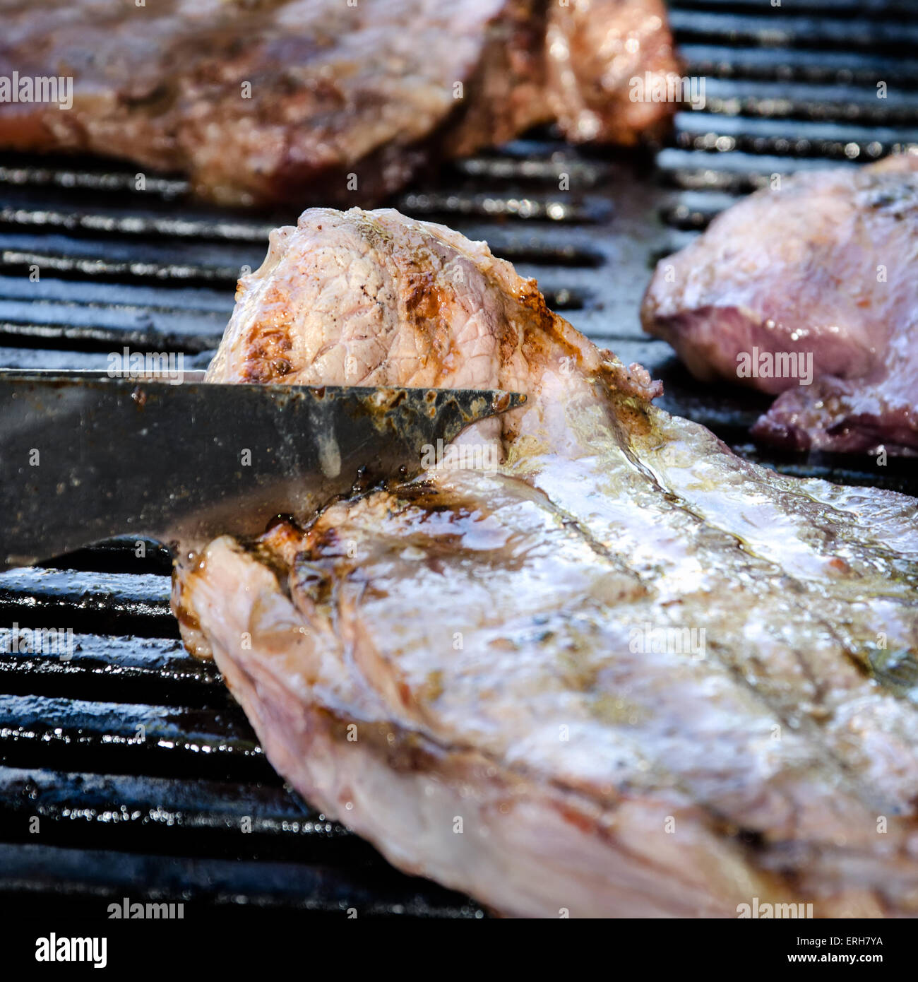 Lamb barbeque, turning steaks on the grill Stock Photo - Alamy