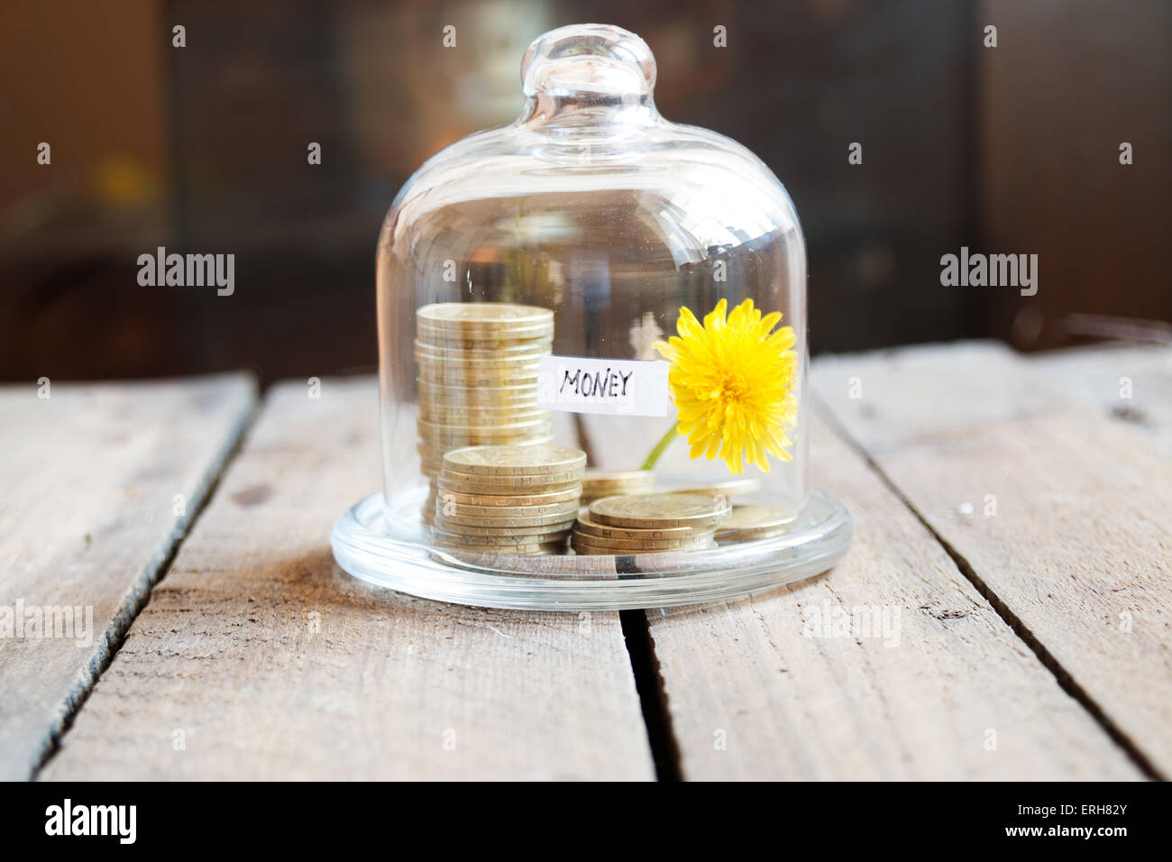Money Concept. Gold coins on a table under a glass cover and yellow ...