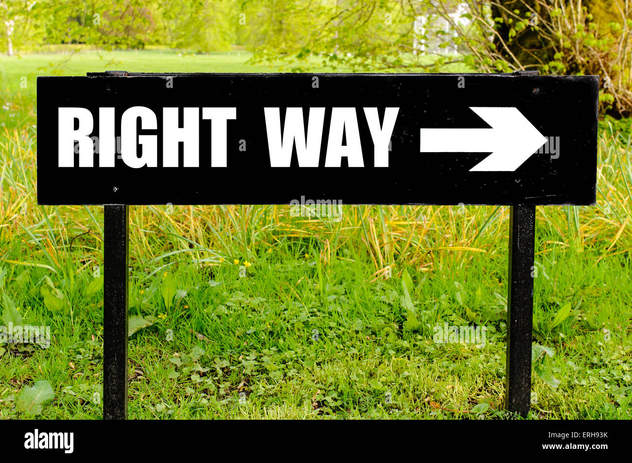 RIGHT WAY written on directional black metal sign with arrow pointing ...