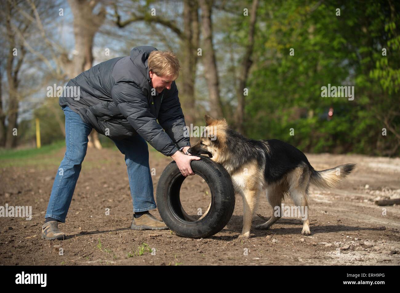 Old man playing with dog hi-res stock photography and images - Alamy