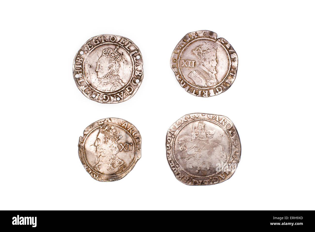 A lot of old silver coins with portraits of kings on a white background ...