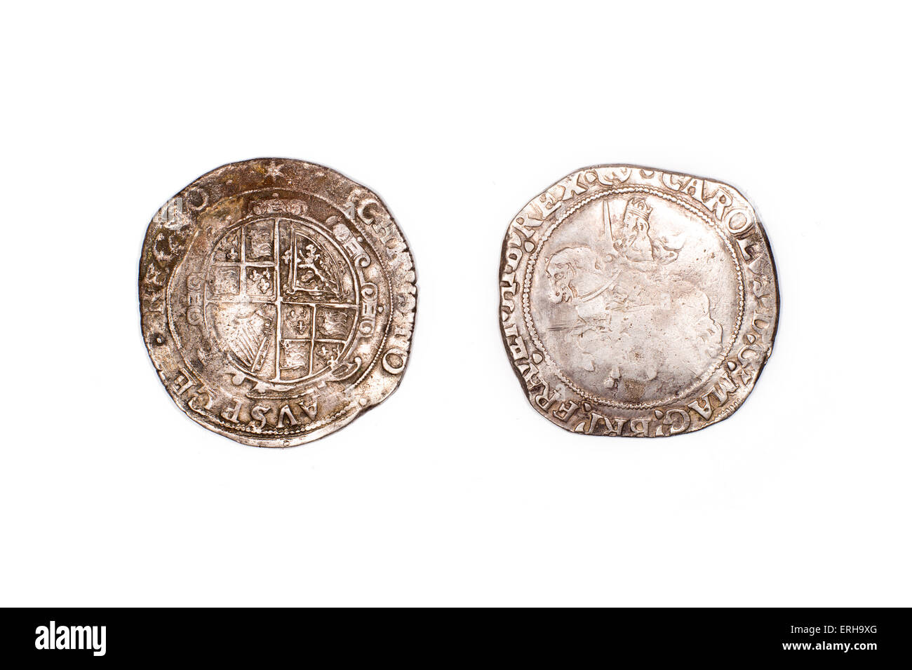 A lot of old silver coins with portraits of kings on a white background ...