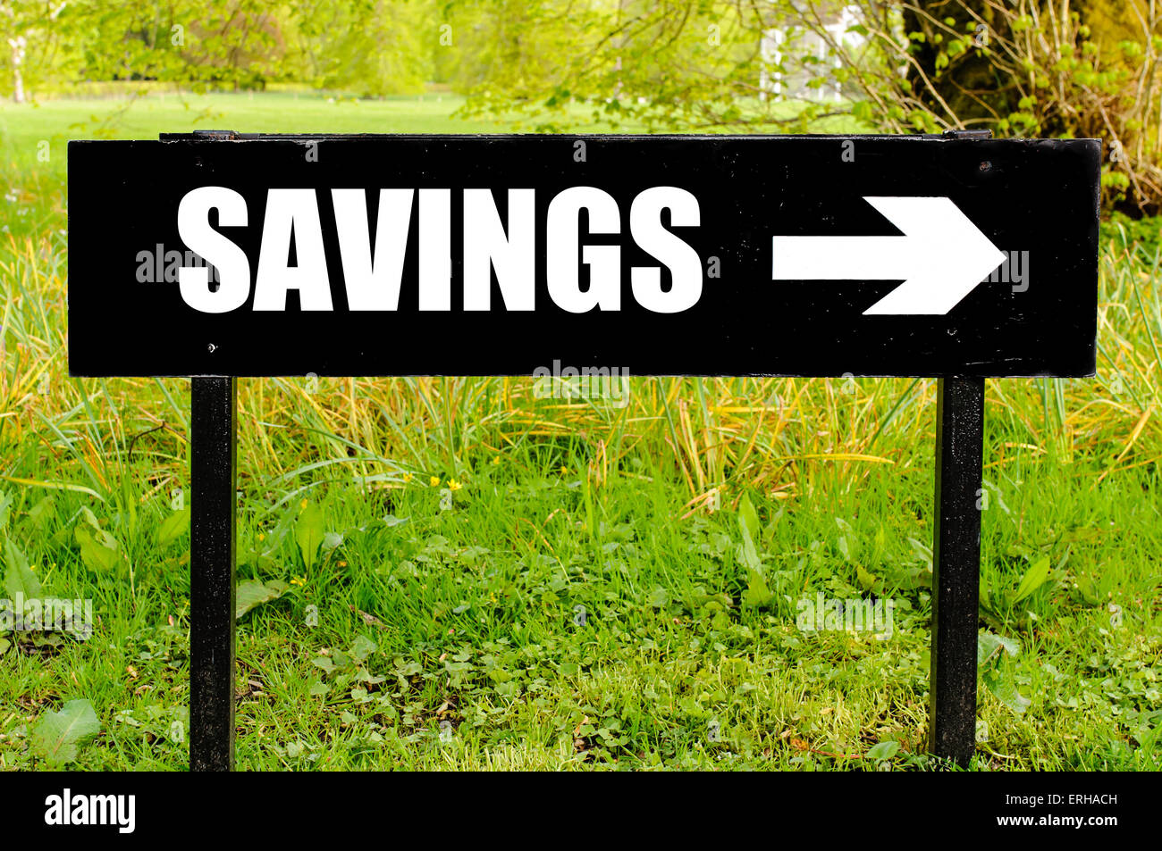 SAVINGS written on directional black metal sign with arrow pointing to ...
