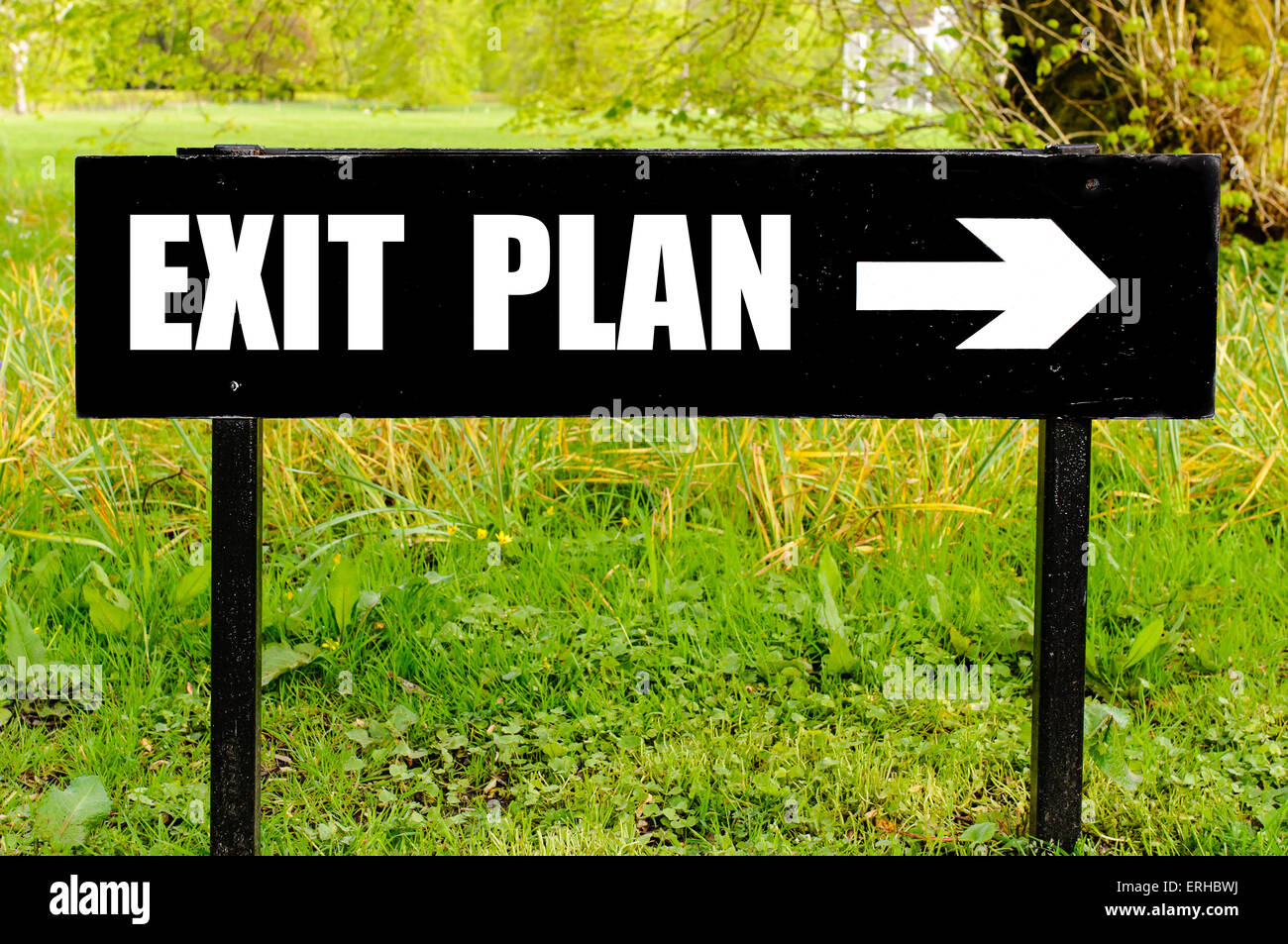 EXIT PLAN written on directional black metal sign with arrow pointing ...