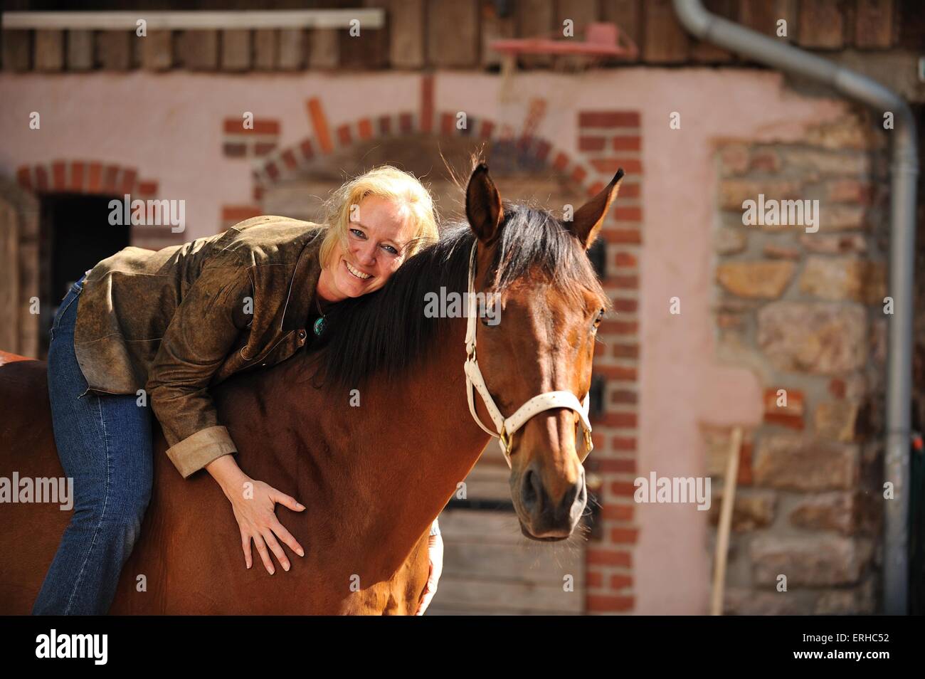 Woman horse stables horse riding hi-res stock photography and images ...
