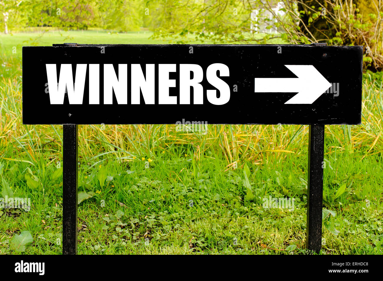 WINNERS written on directional black metal sign with arrow pointing to ...