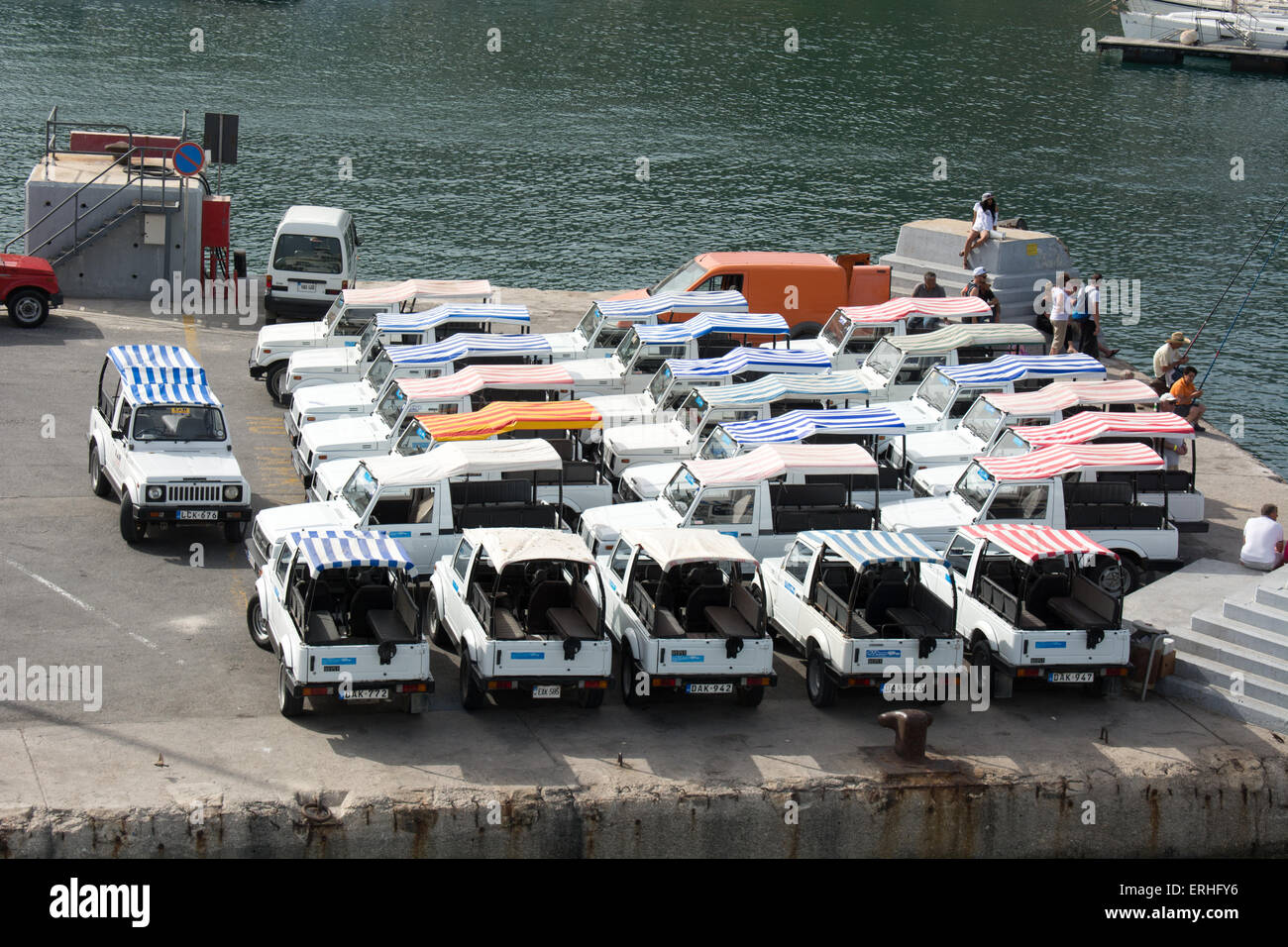 24 Maruti Suzuki Gypsy off road tour vehicles wait on the quayside of ...
