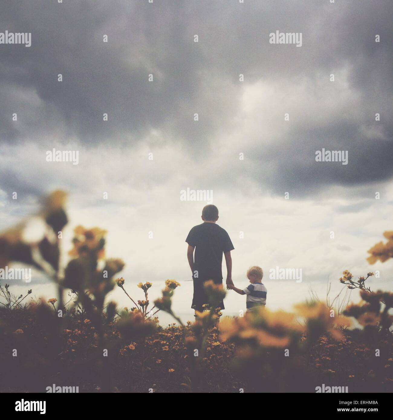 Two boys holding hands hi-res stock photography and images - Alamy