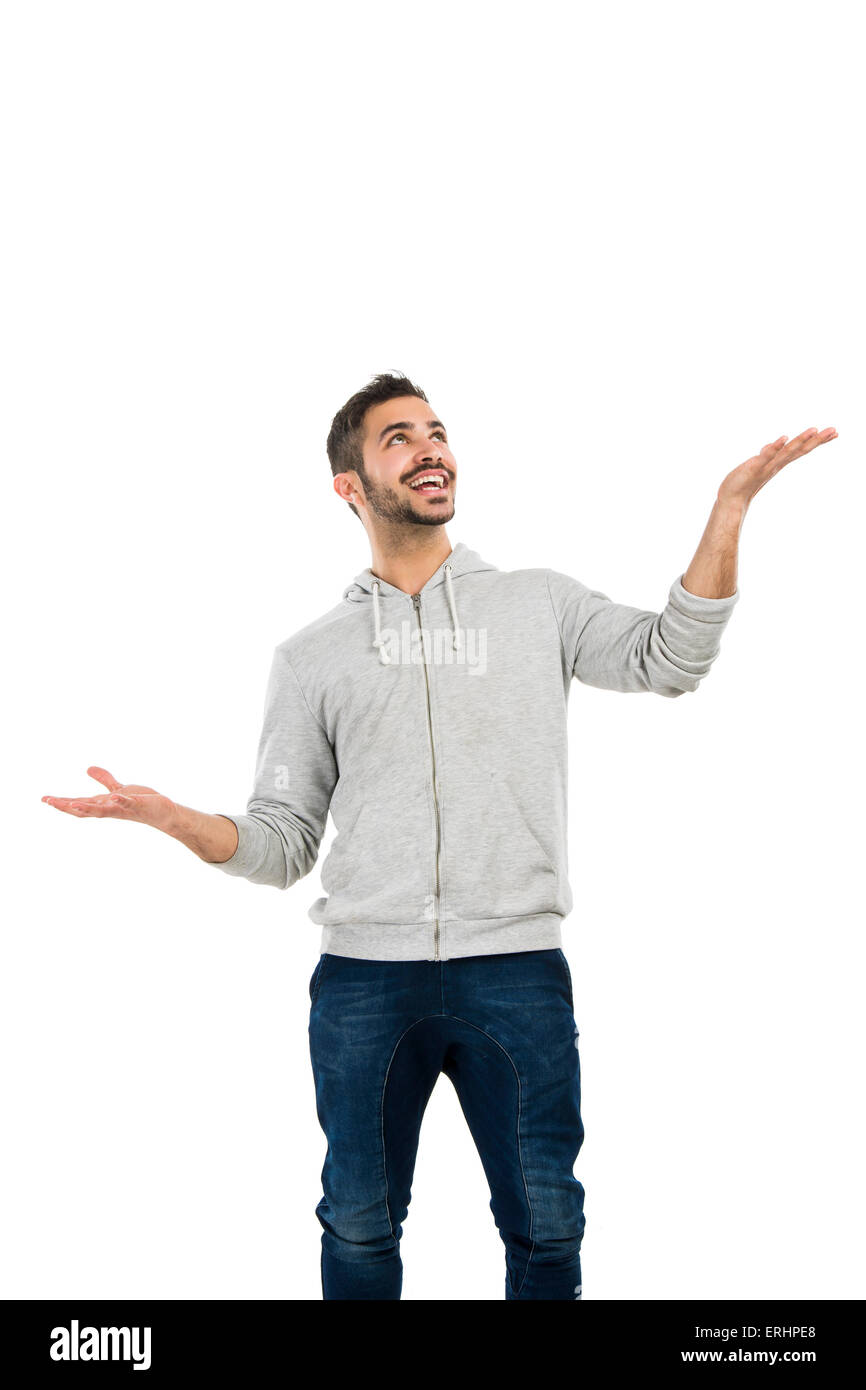 Good looking young man catching something with is hands, with copy ...