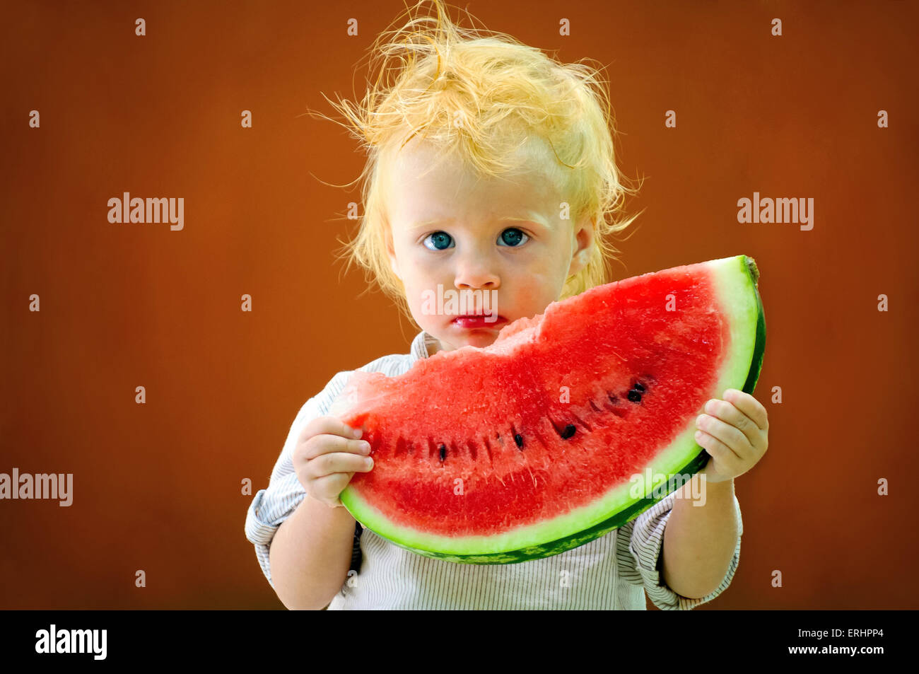Cute infant baby with a delicious watermelon Stock Photo - Alamy
