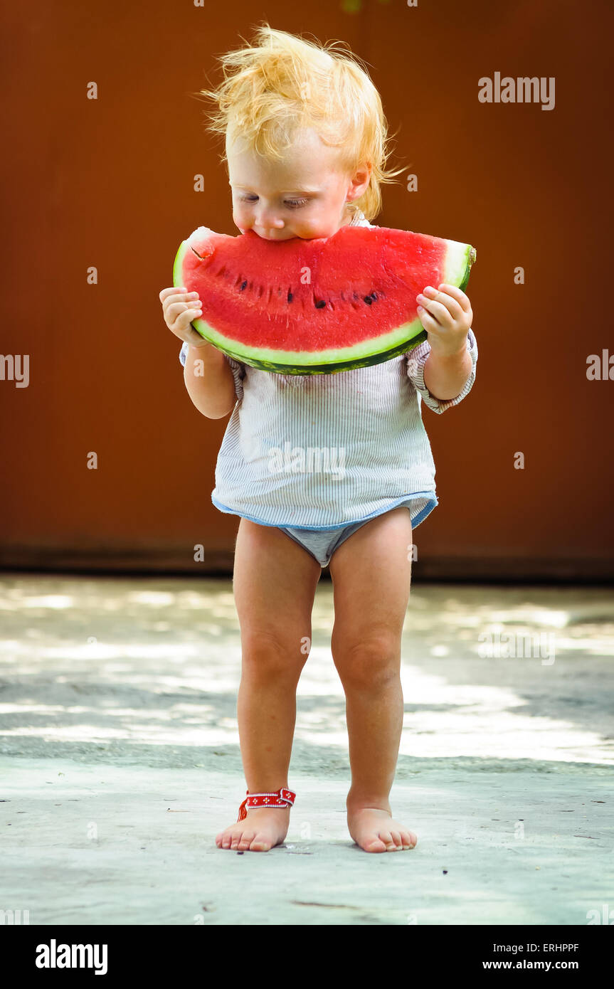 Cute infant baby with a delicious watermelon Stock Photo - Alamy
