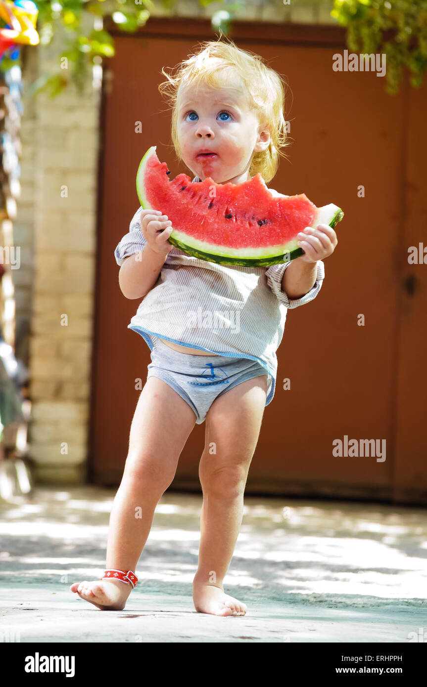 Cute infant baby with a delicious watermelon Stock Photo - Alamy